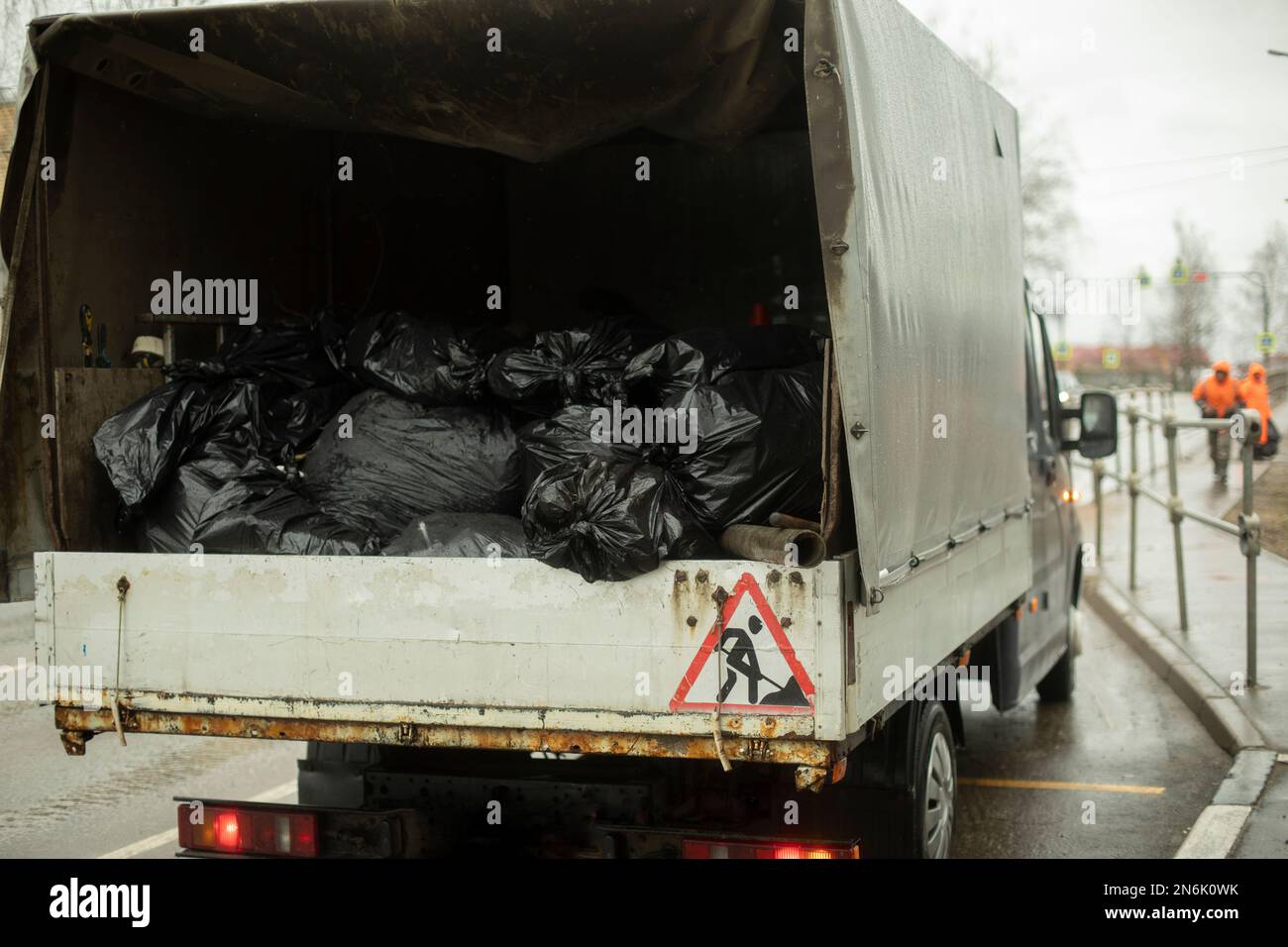 Bags of garbage in back of car. Transportation of waste in black bags ...