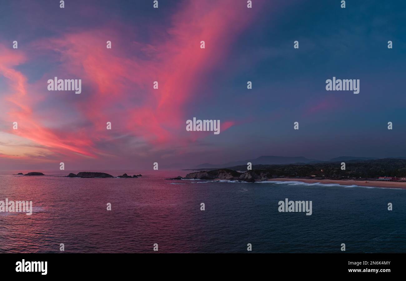 A drone shot of the Faro de Bucerias Beach (Playa Maroma) at sunset in ...
