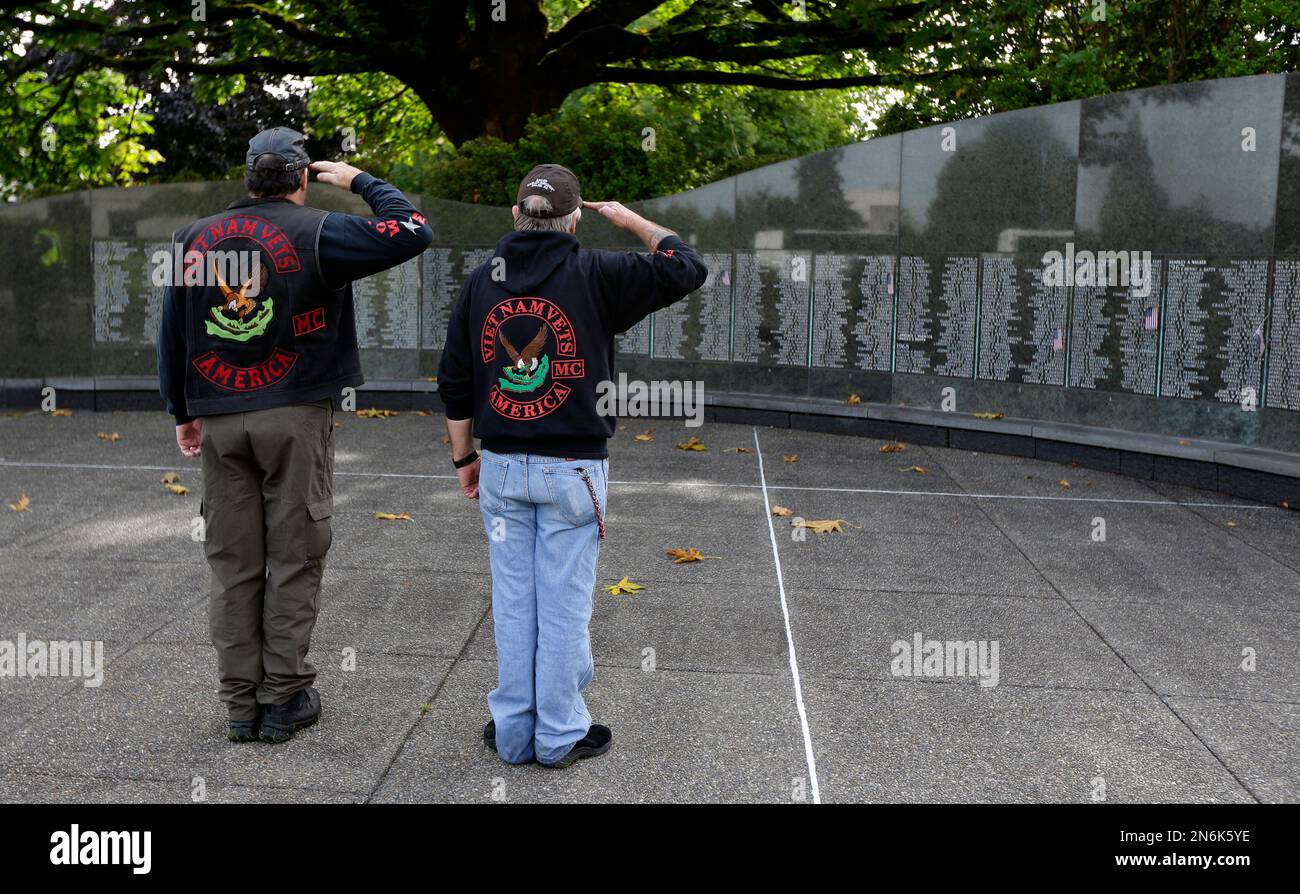 Bob Logan, left, of Rainier, Wash., and Allen Arthur, right, salute as ...