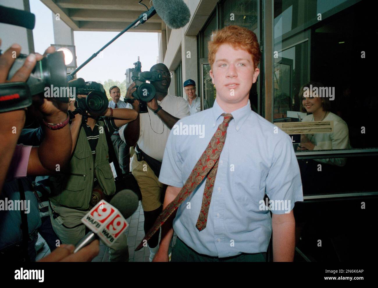 Webb Haymaker is followed by media at the noon recess pf the Peairs ...