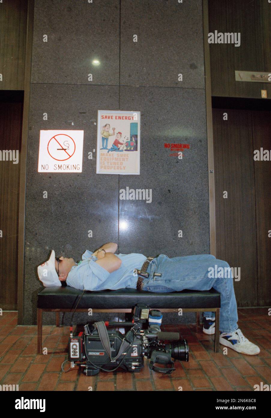 Photographer sleeping in the lobby at the Baton Rouge Courthouse during ...