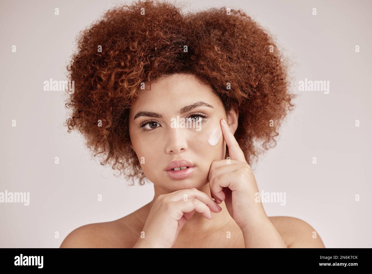 Skincare, portrait of black woman with cream on serious face, afro and ...