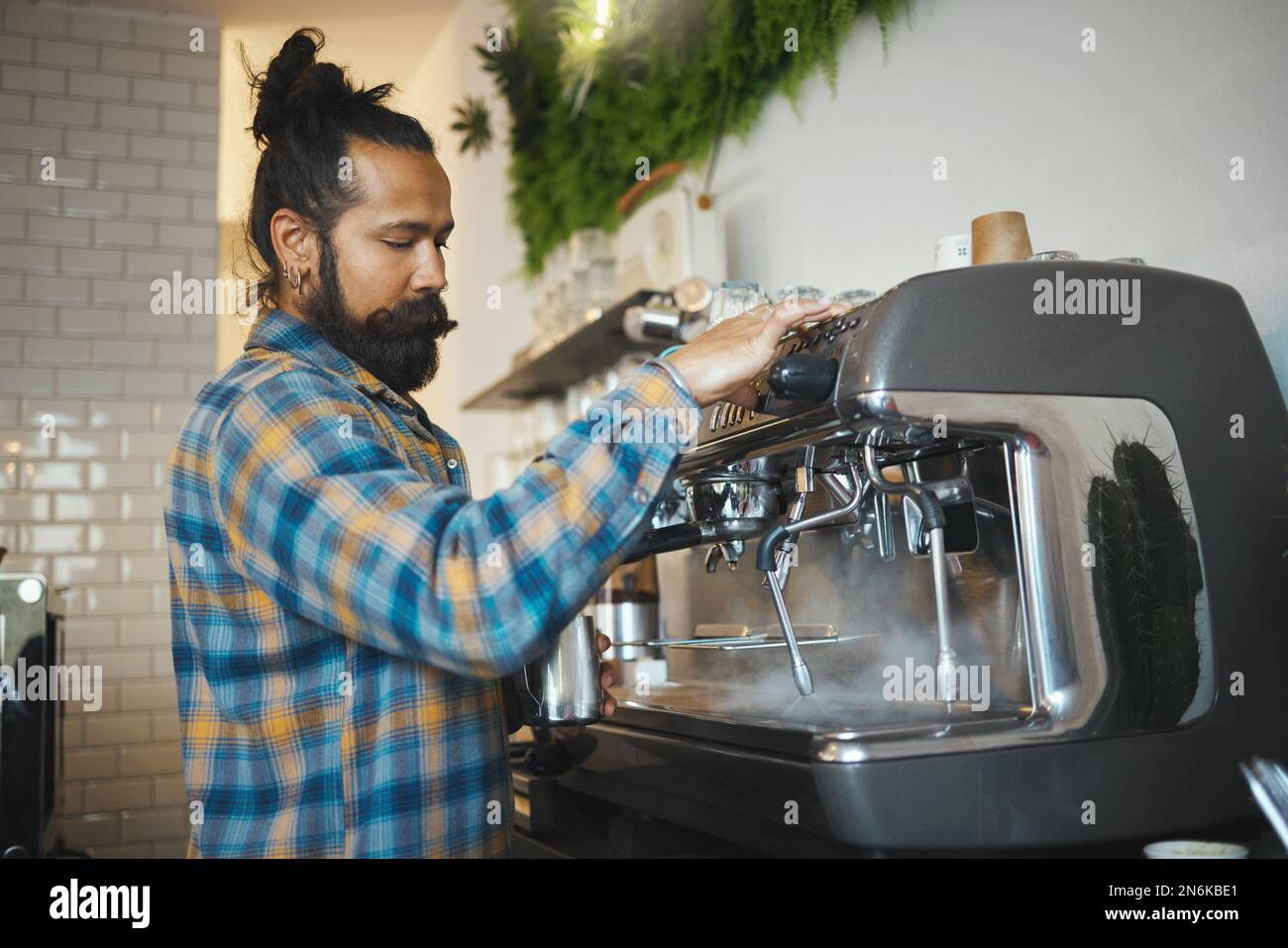 Man in cafe, barista working machine and create drink with focus and ...