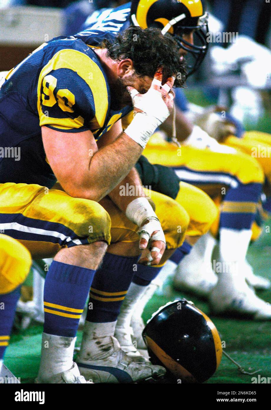 Los Angeles Rams nose tackle Shawn Miller (98) holds his head as the ...
