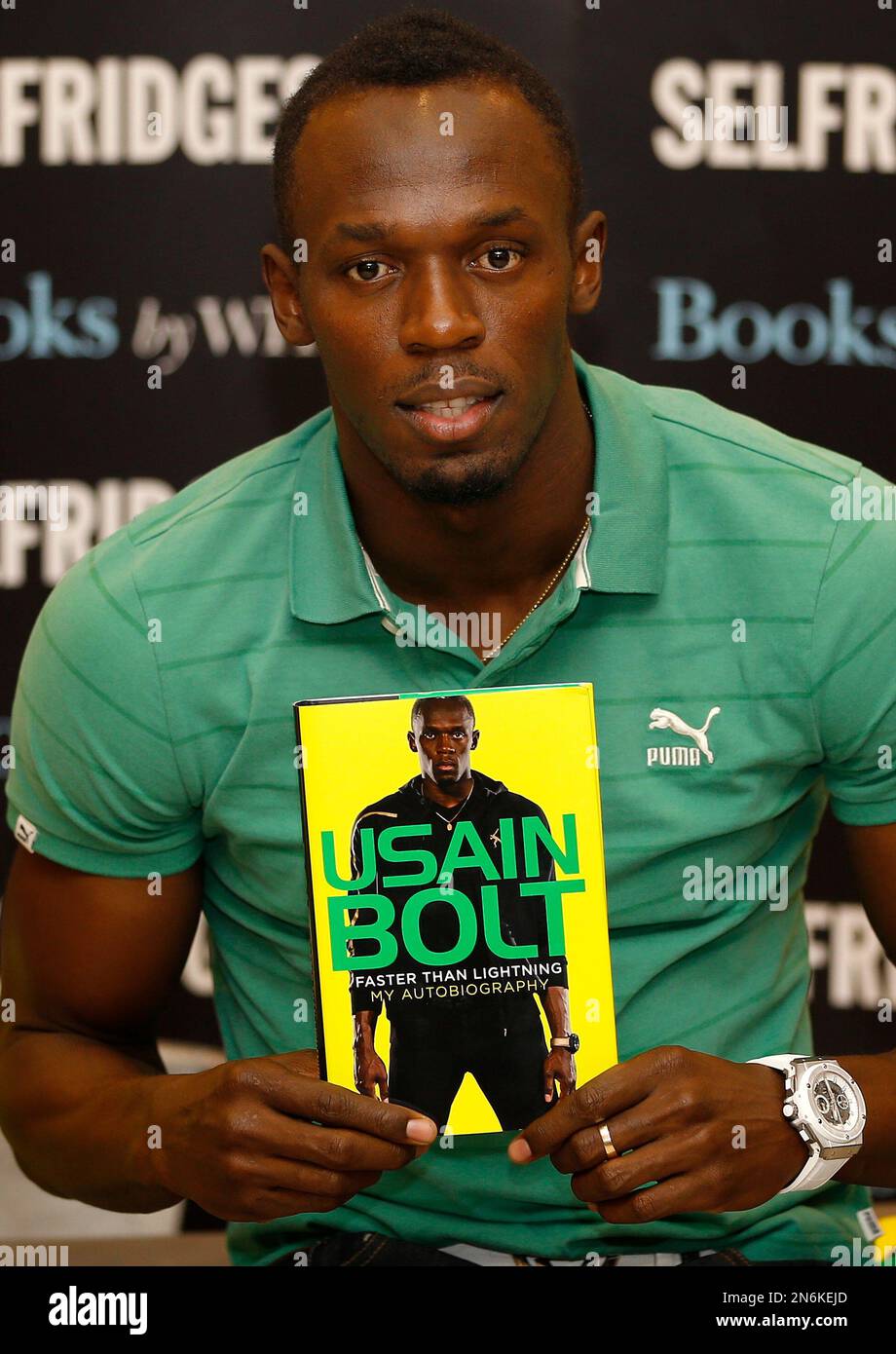 Usain Bolt, Jamaican athlete, poses for the media with a copy of his ...