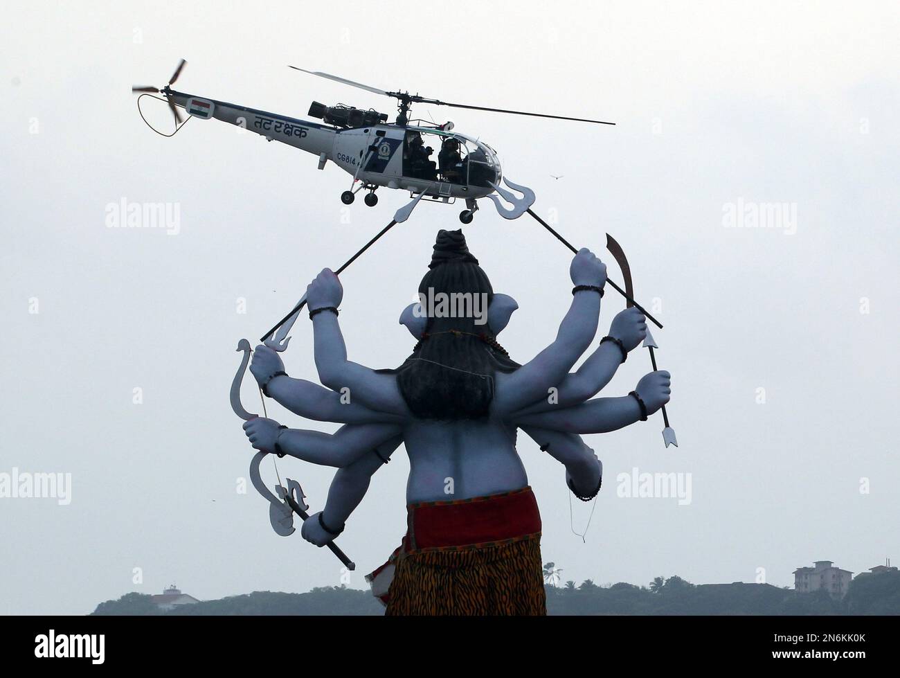 An Indian coast guard chopper patrols as an idol of Hindu elephant ...