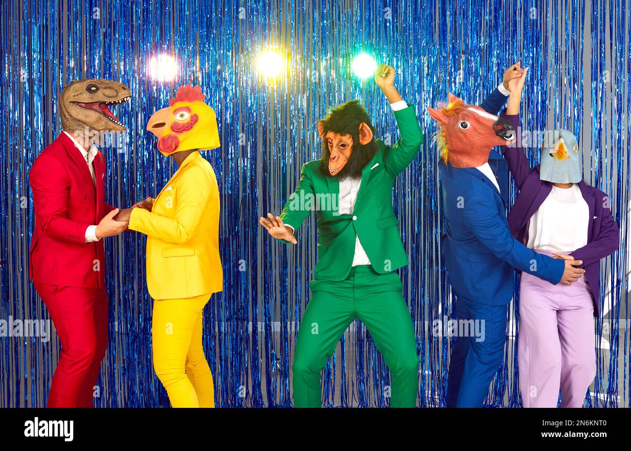 People in colorful suits and funny animal masks dancing and having fun ...
