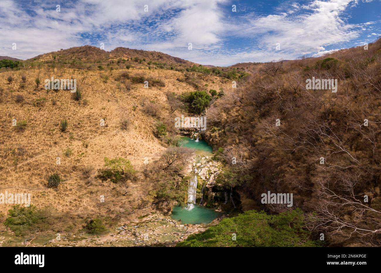 The Comala waterfall under blue cloudy sky on a sunny day in the town ...