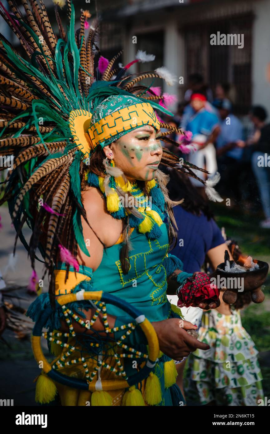 A female with customs wearing native american headdress during the ...