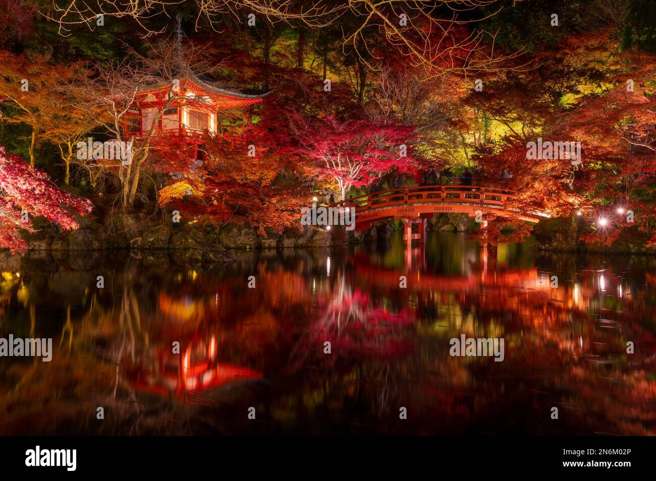 A red bridge and the reflection of colorful fairy trees by Daigo-ji ...