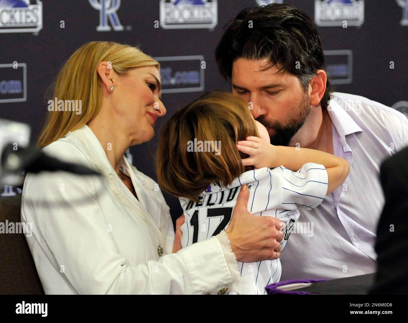 Colorado Rockies first baseman Todd Helton, right, gets a kiss from his ...