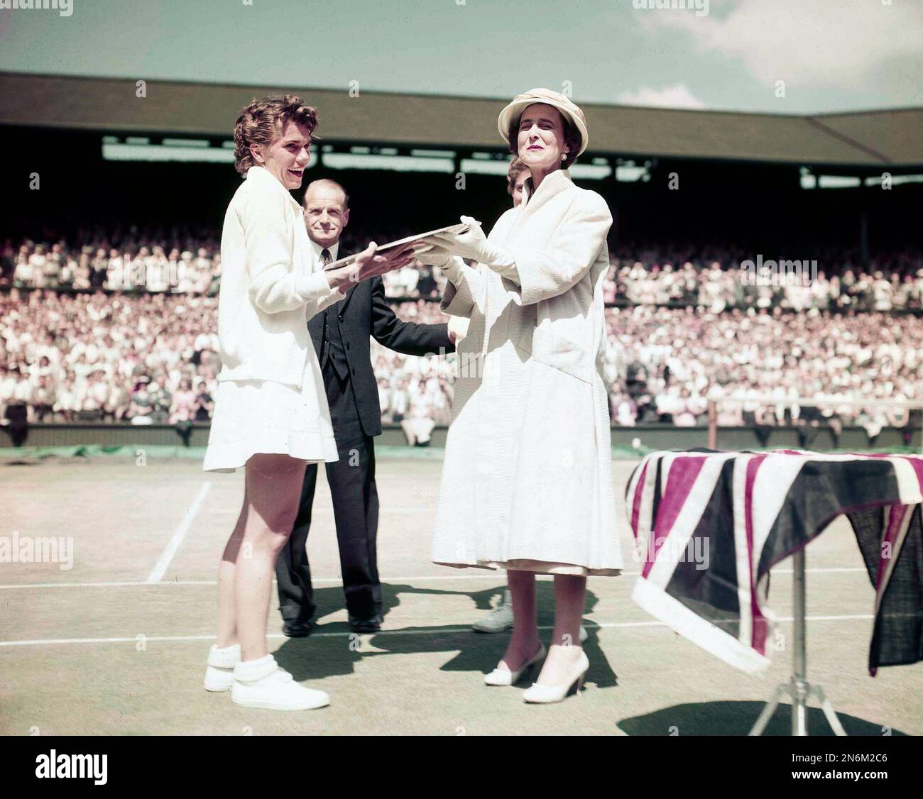 Tennis player Shirley Fry, left, receives her trophy for winning the ...
