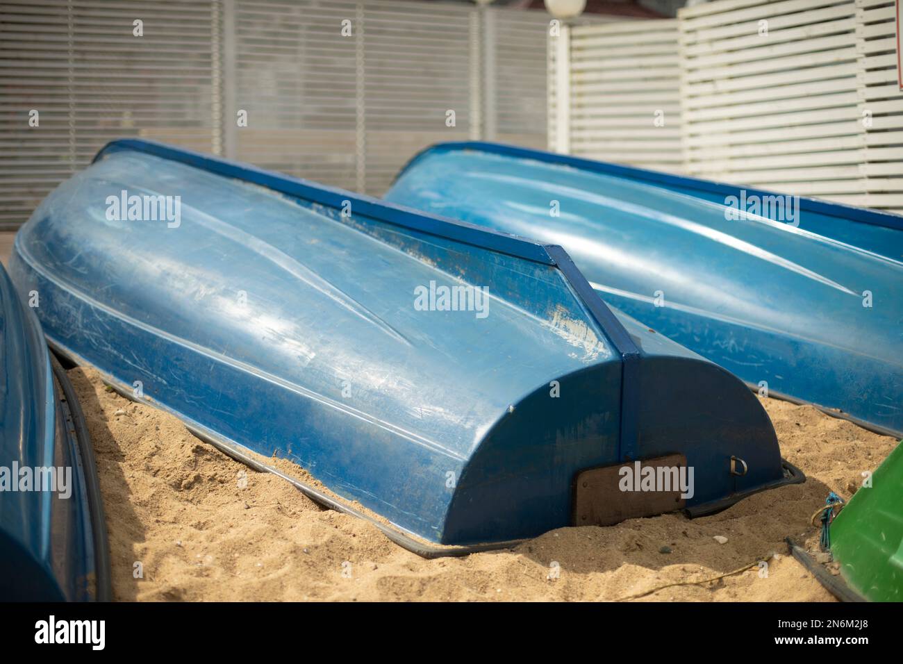 Blue boats on sand. Boat station. Boats dry up on shore Stock Photo - Alamy