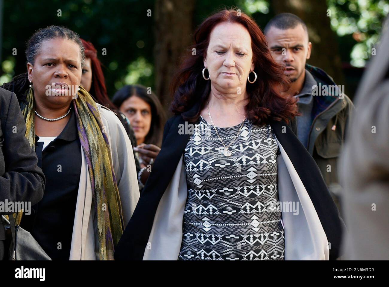 Pam Duggan, mother of Mark Duggan, centre, arrives with her son Marlon ...