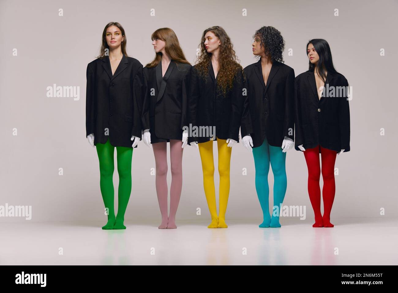 Studio shot of young stylish beautiful fashion models in black jackets ...