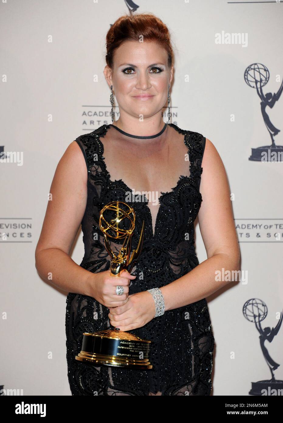 Courtney Webster poses backstage with the award for outstanding ...
