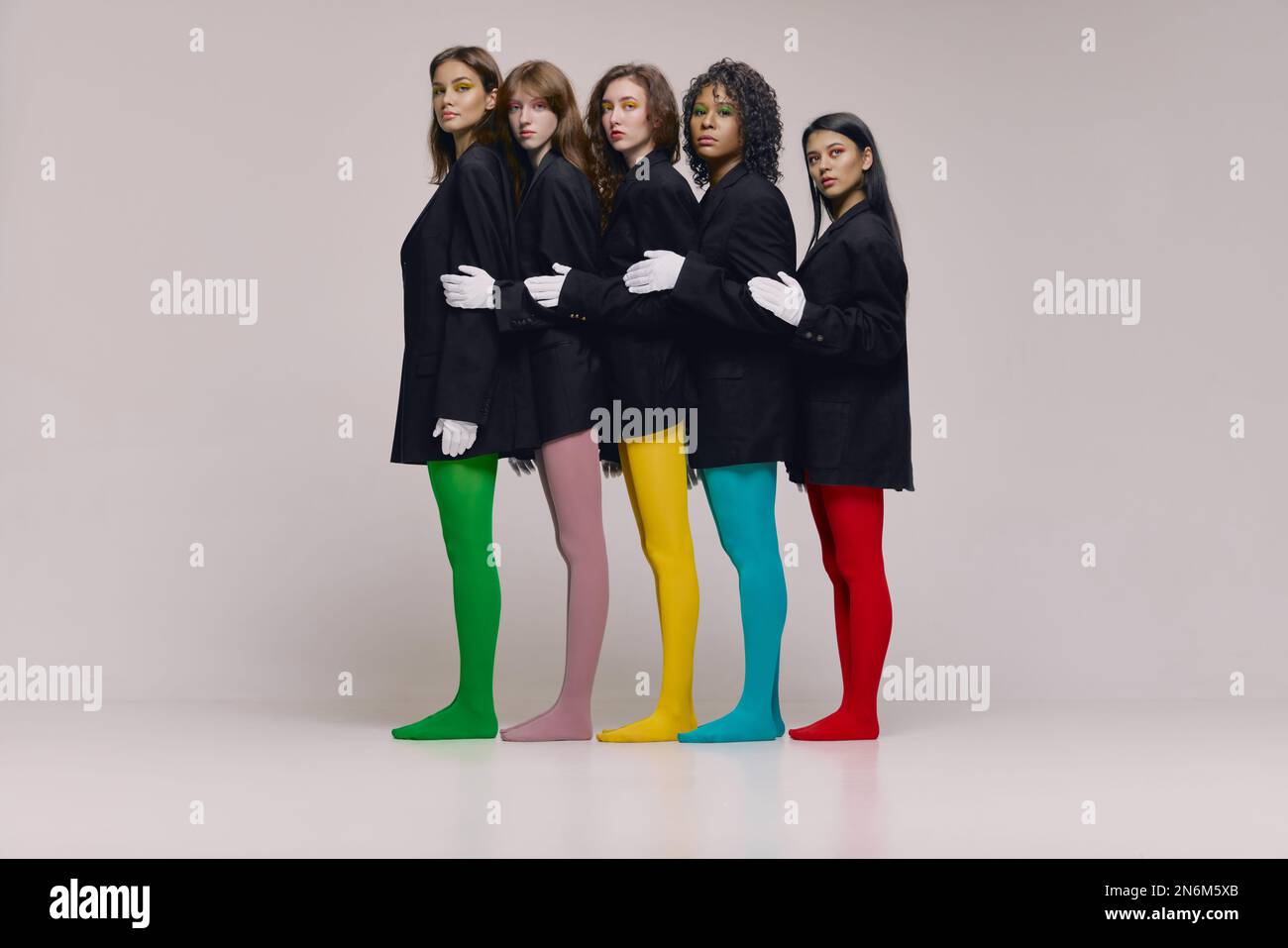 Group of young diverse beautiful women in black jackets and multi ...