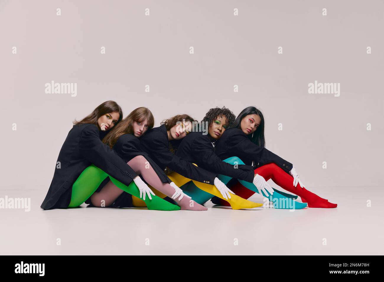 Portrait of young beautiful different women in black jackets and ...