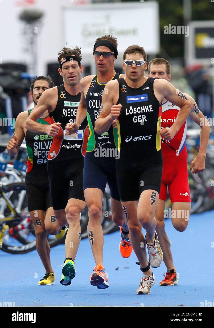 Sven Riederer of Switzerland, second left, races in the run portion of ...