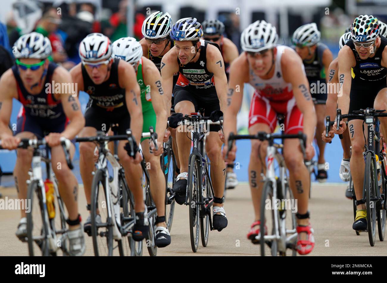 Sven Riederer of Switzerland, center (7), races in the cycle portion of ...