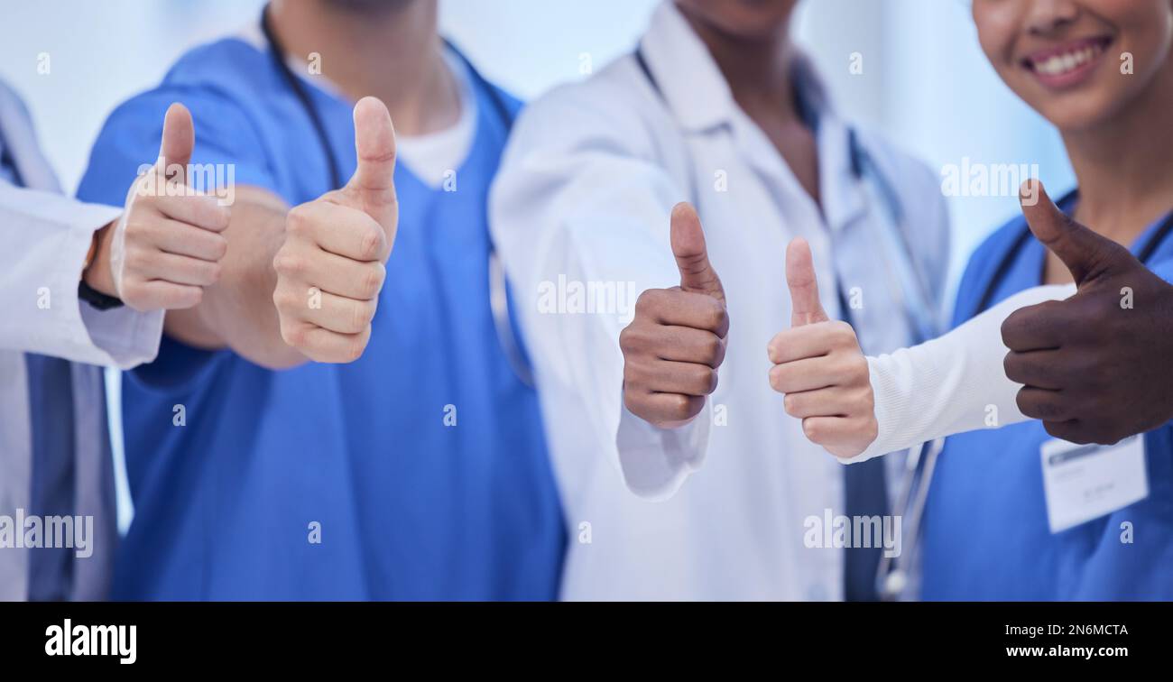 Healthcare, teamwork and group of doctors with thumbs up, hands together, collaboration and ...