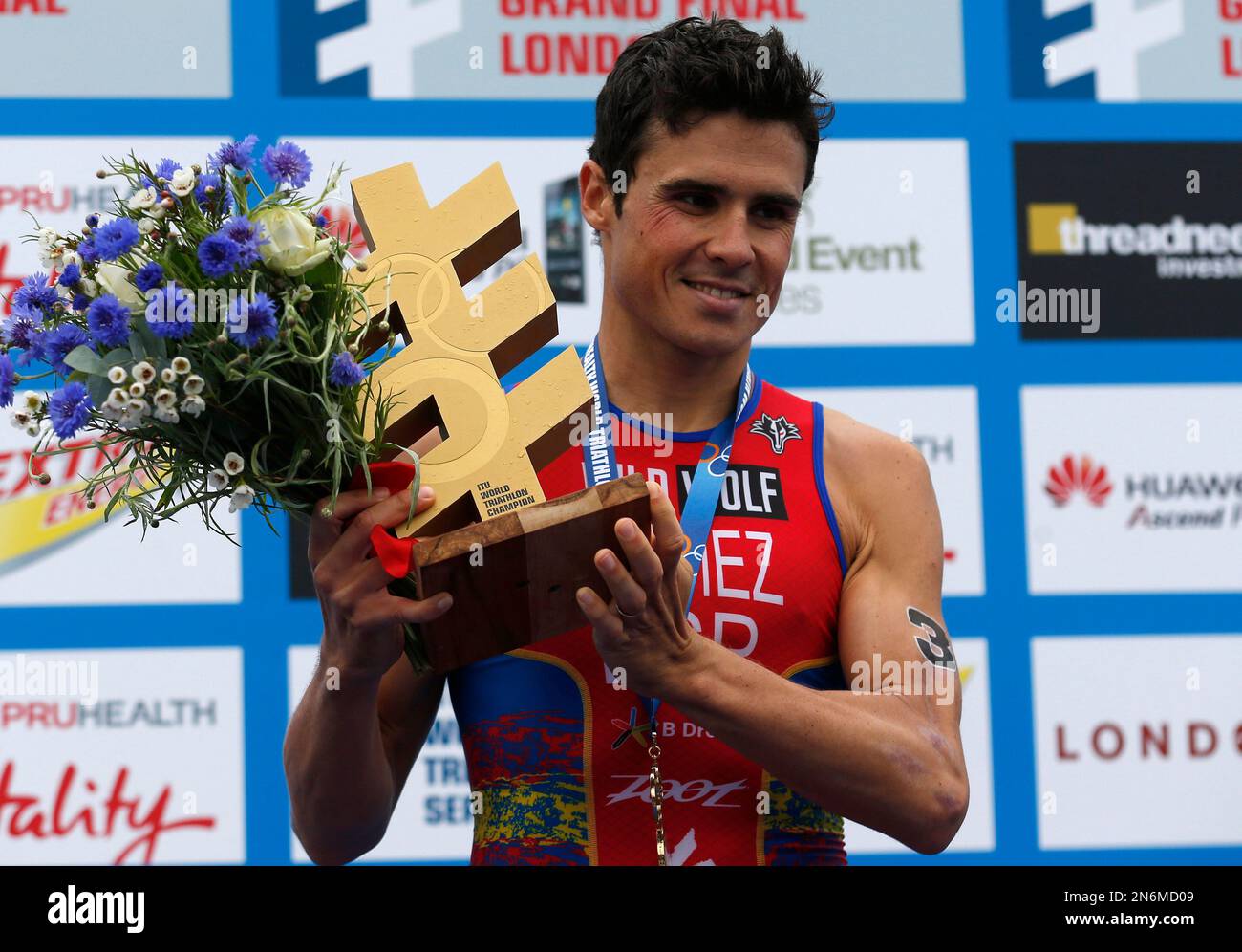 Javier Gomez of Spain poses with his world series champion trophy ...