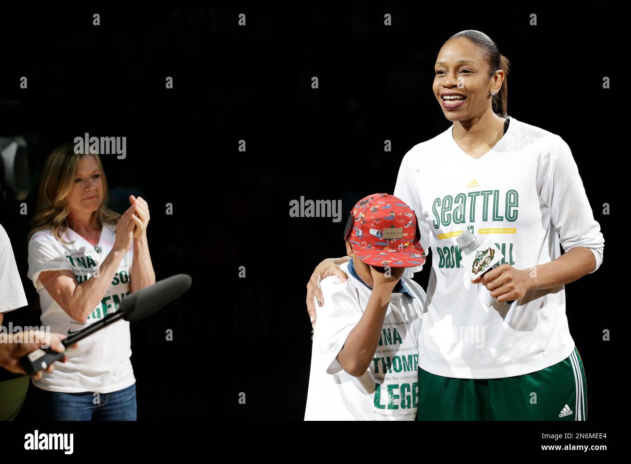 Seattle Storm's Tina Thompson stands with her son, Dyllan, as she ...