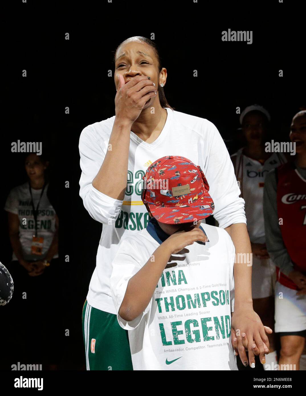 Seattle Storm's Tina Thompson stands with her son, Dyllan, as she looks ...