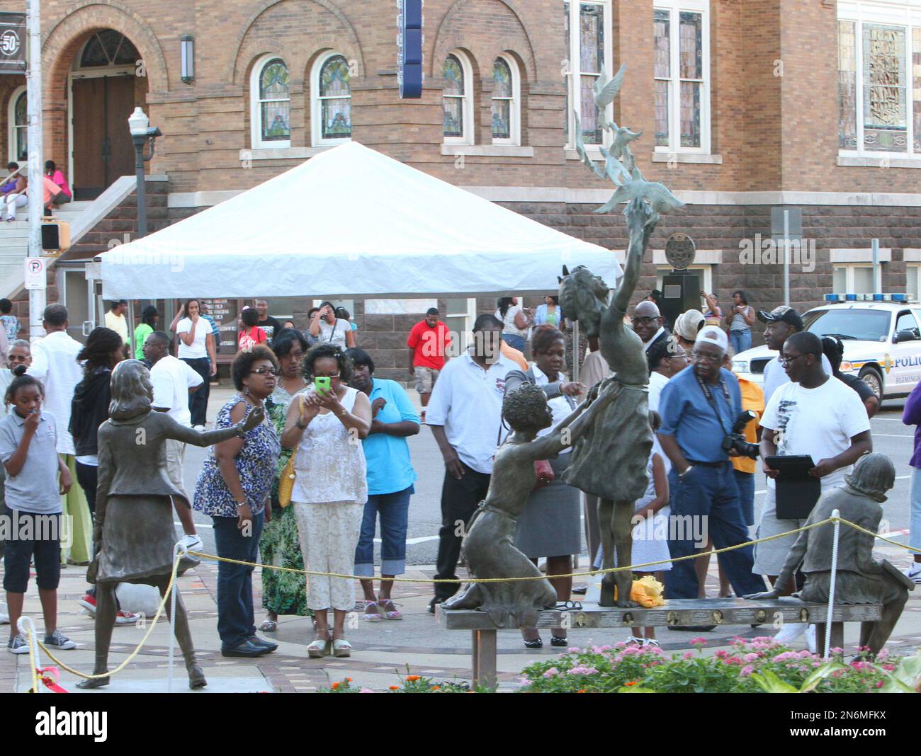 People surround "The Four Little Girls", a sculpture memorial honoring ...