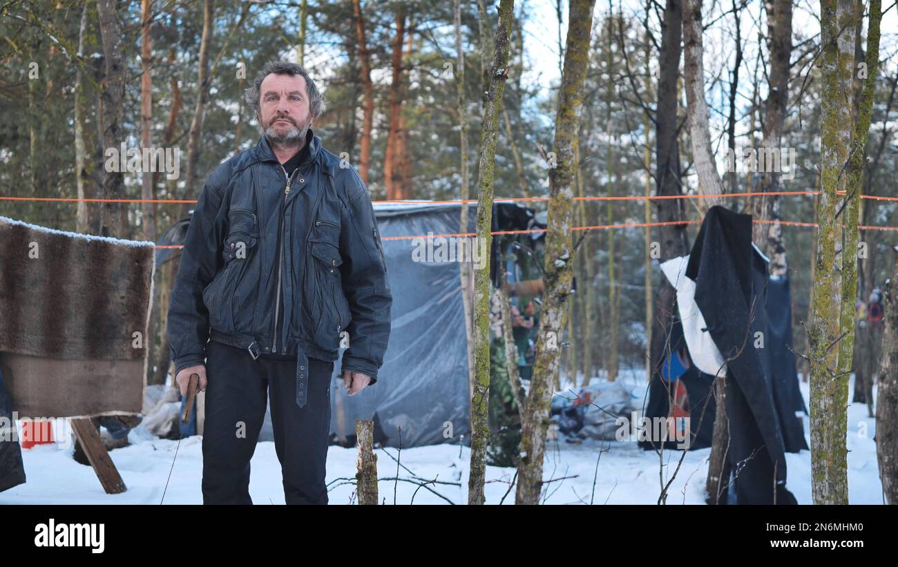 A homeless man poses in the woods in front of his hut Stock Photo - Alamy