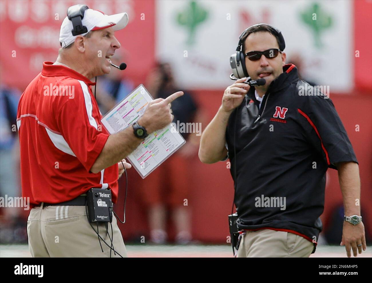 Nebraska head coach Bo Pelini, left, calls instructions with defensive ...