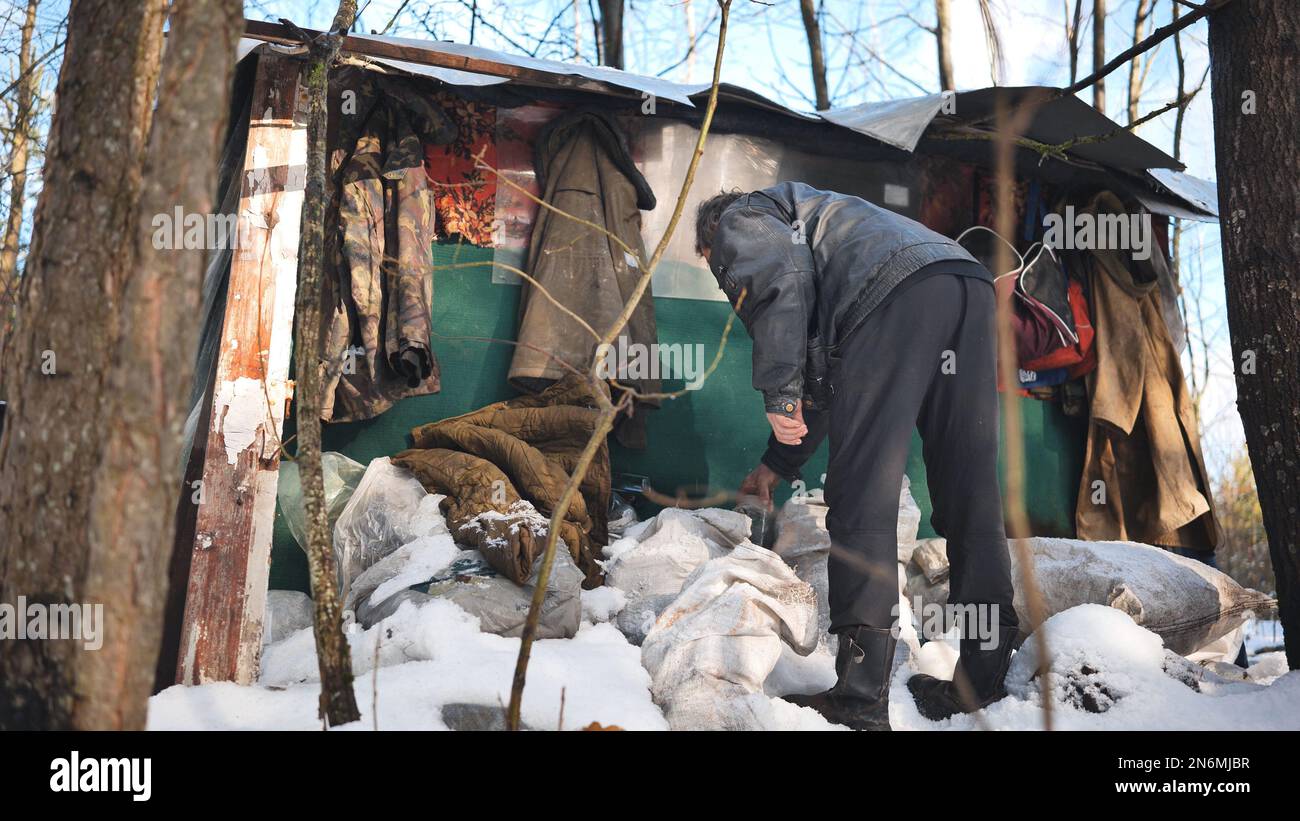 A homeless man goes through things at his cabin in the woods in winter ...