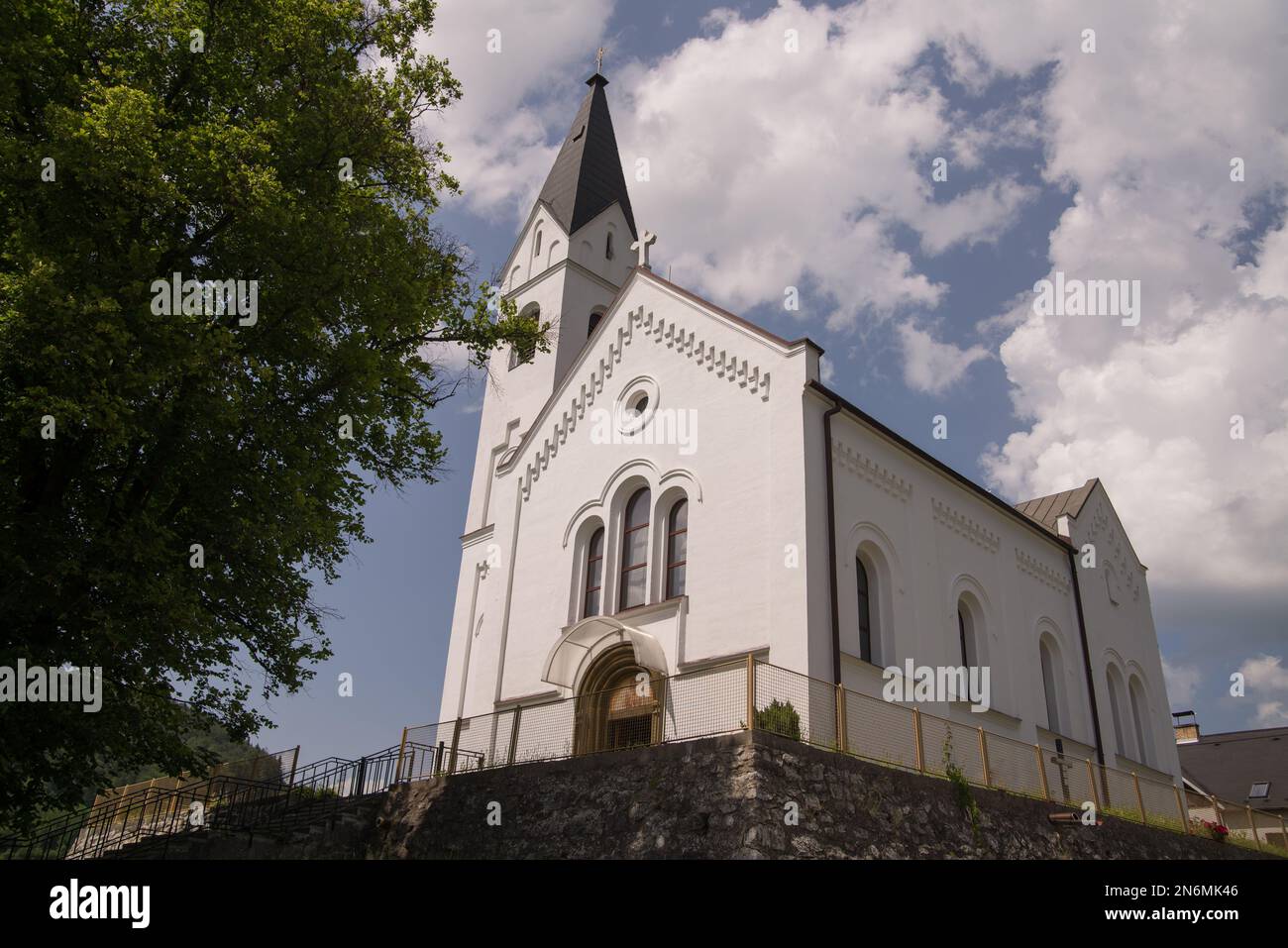 catholic church in summer time with clouds in sky Stock Photo - Alamy