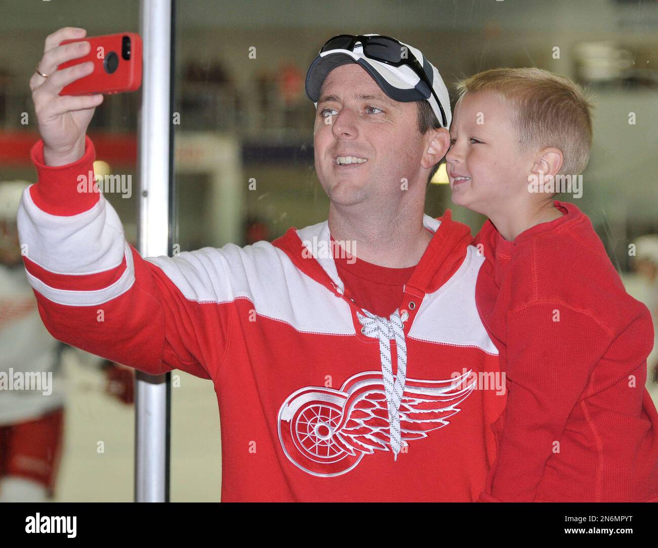 Curt Wilson, of Traverse City, Mich., takes a photo with his son, Grant ...