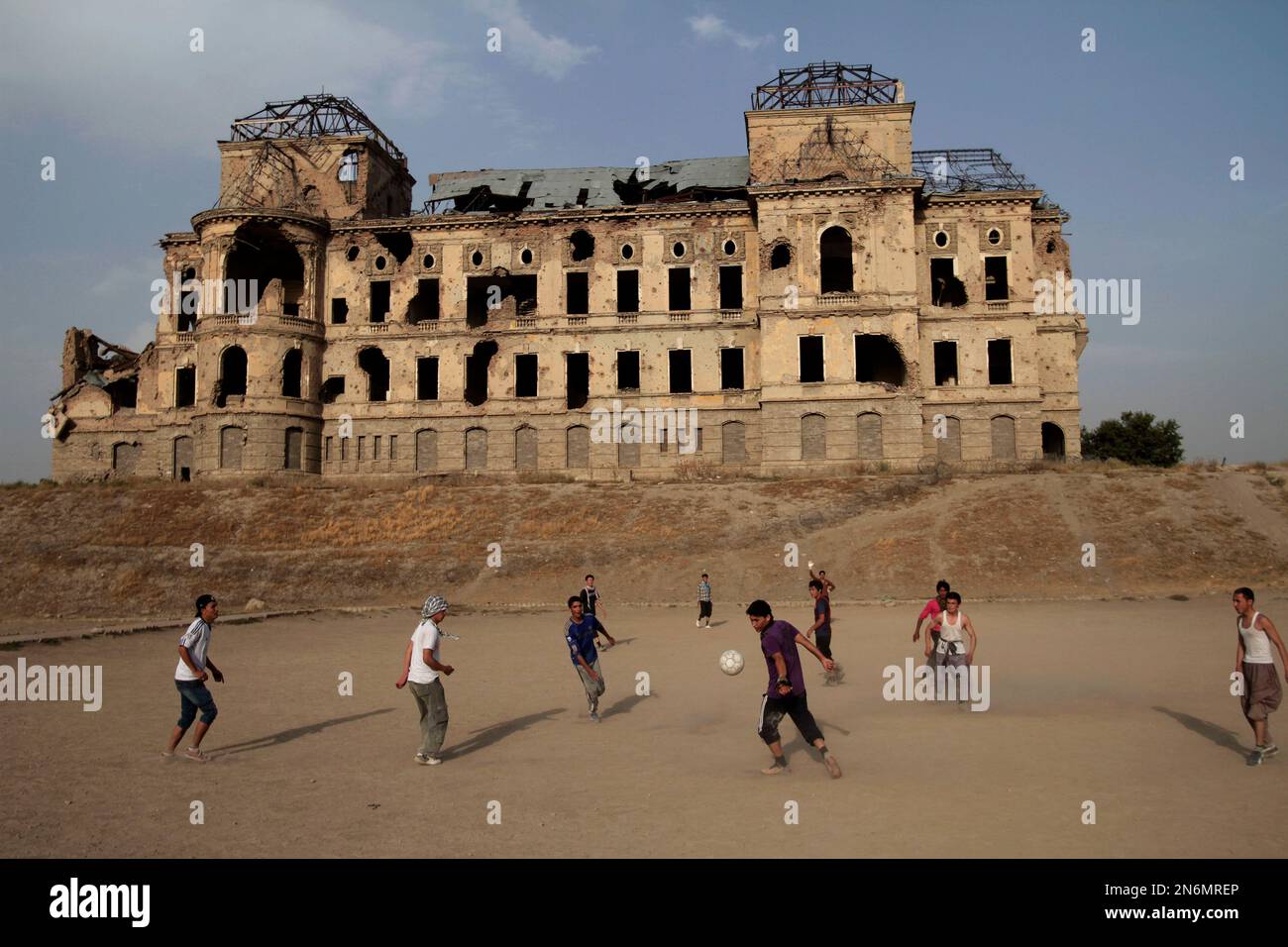 Afghan boys play soccer by the palace of the late King Amanullah Khan ...