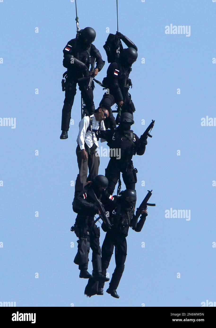 Indonesian special forces soldiers rescuing a "hostage" are harnessed ...