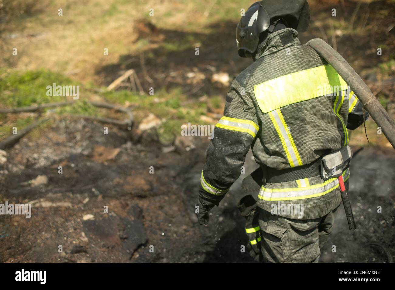 Firefighter puts out fire. Lifeguard pours water from hose ...