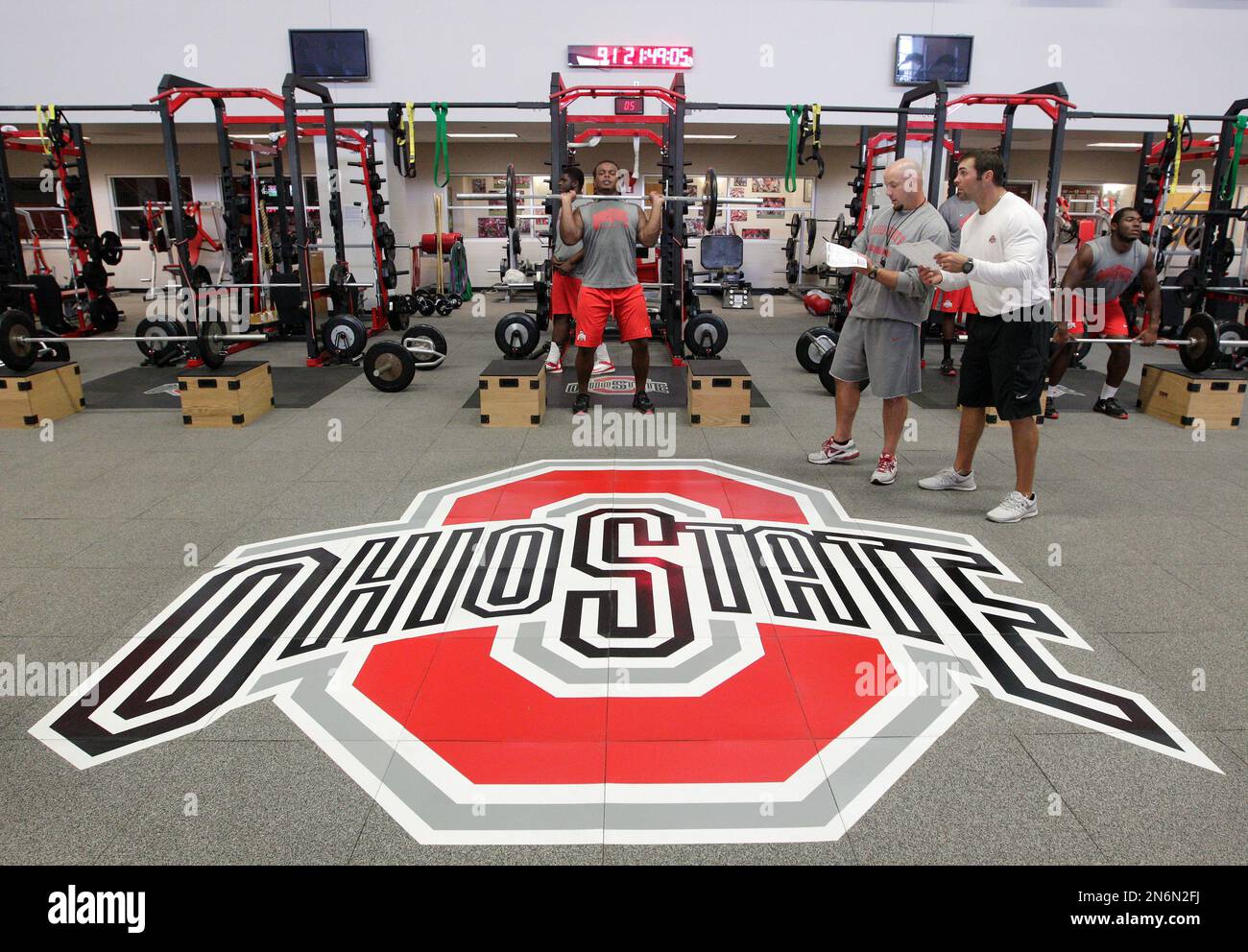 In this Aug. 30, 2013 photo, Ohio State football coaches discuss ...