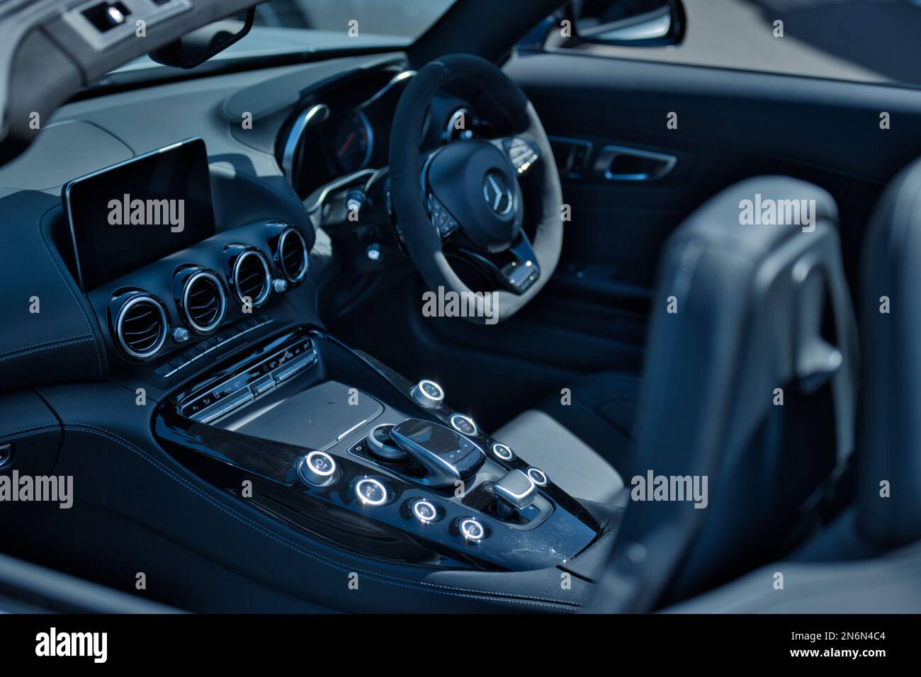 A scene of the black interior of a Mercedes Benz Supercar illuminated ...