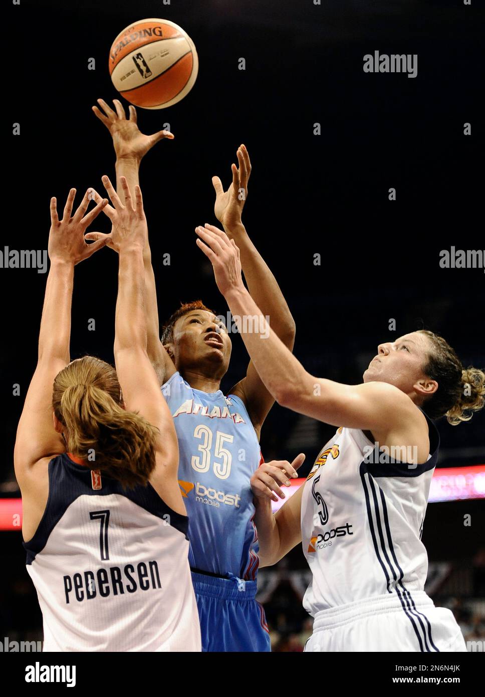 Atlanta Dream's Angel McCoughtry, center, drives to the basket as ...