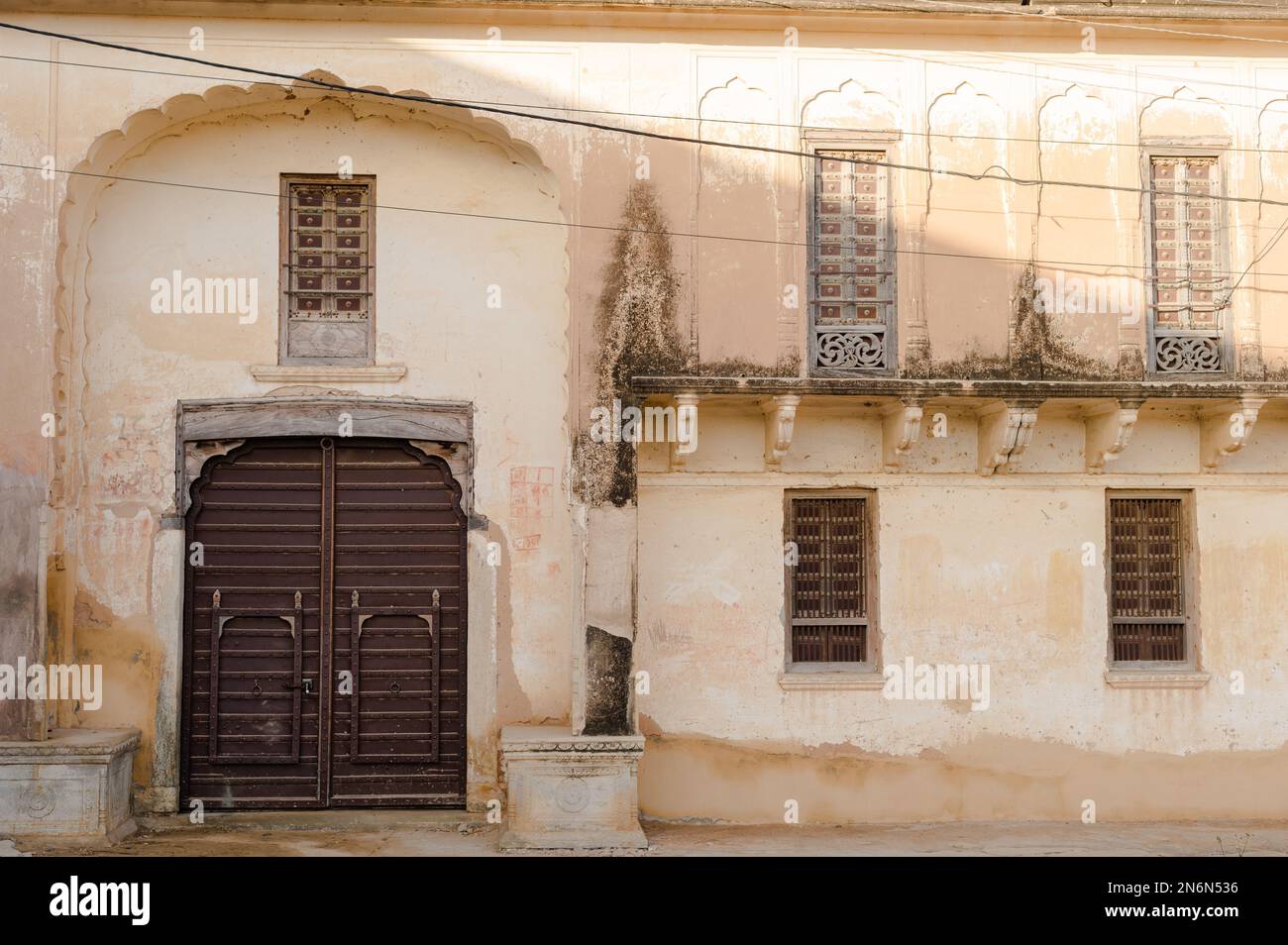 An old house with a brown gate and small long windows of the Mandawa ...