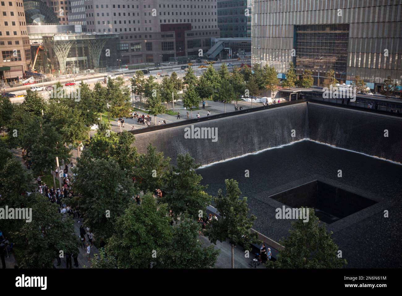 People gather around the North Tower pool during memorial ceremonies ...