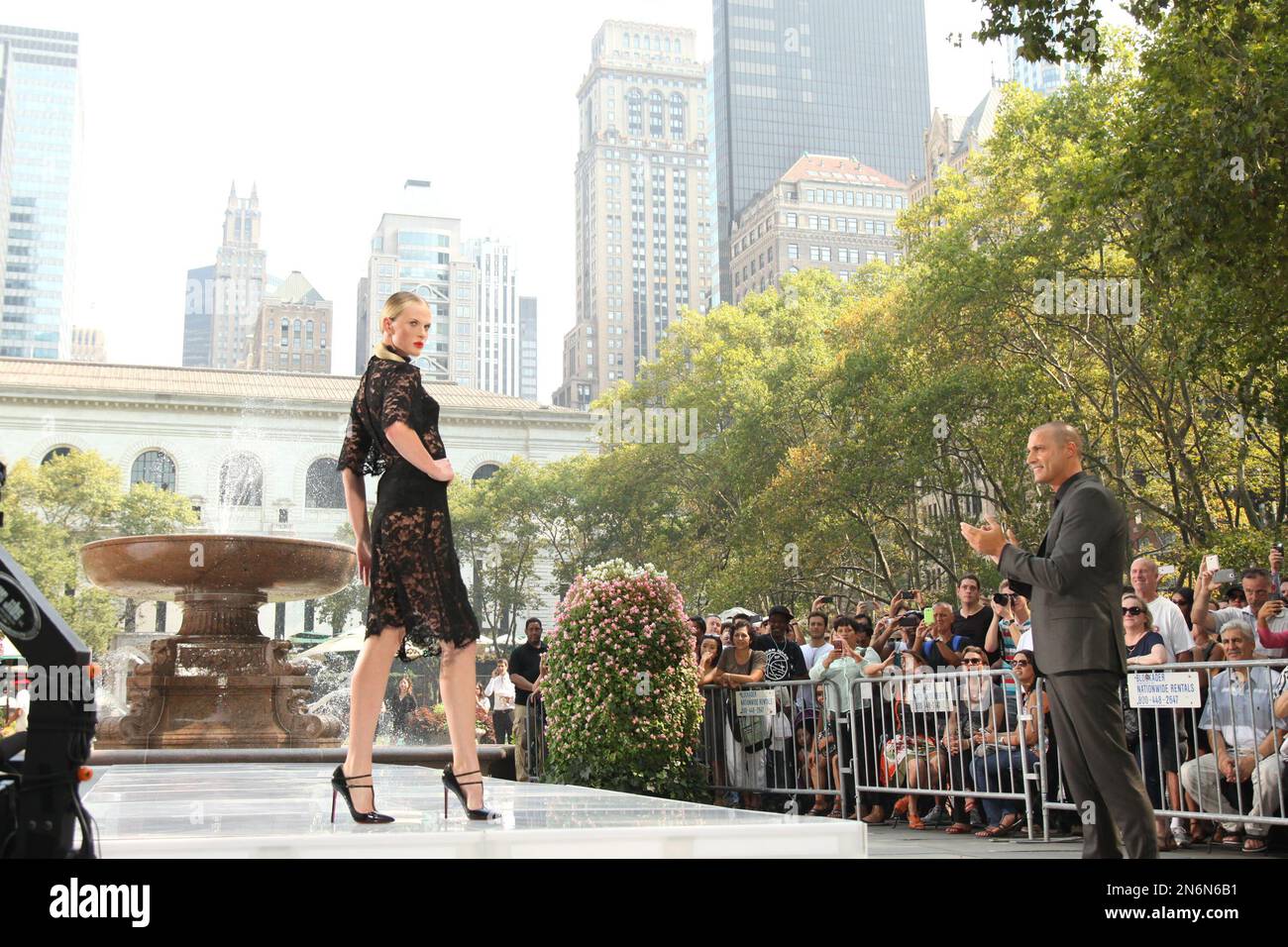 Supermodel Coach Anne V walks the runway as host Nigel Barker cheers at ...