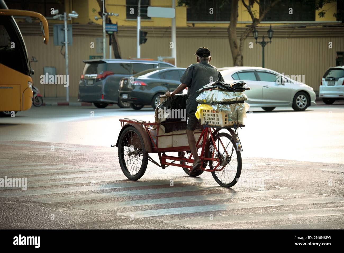 Bangkok, Thailand – Jan 18, 2013: Old man rides on his tricycle. A ...
