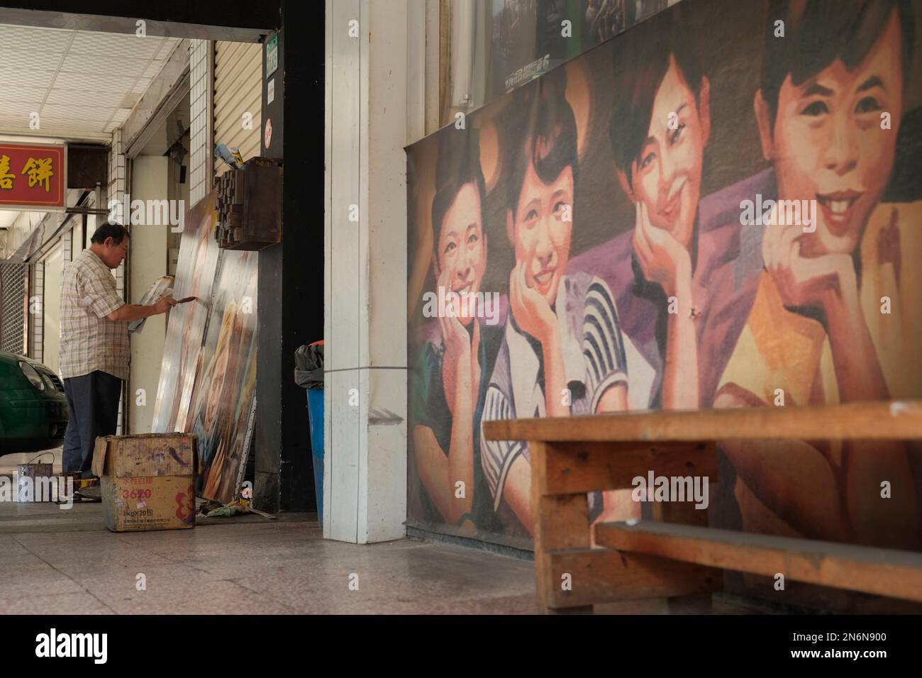 In this Friday, Sept. 6, 2013 photo, local artist Yan Jhen-fa paints a ...