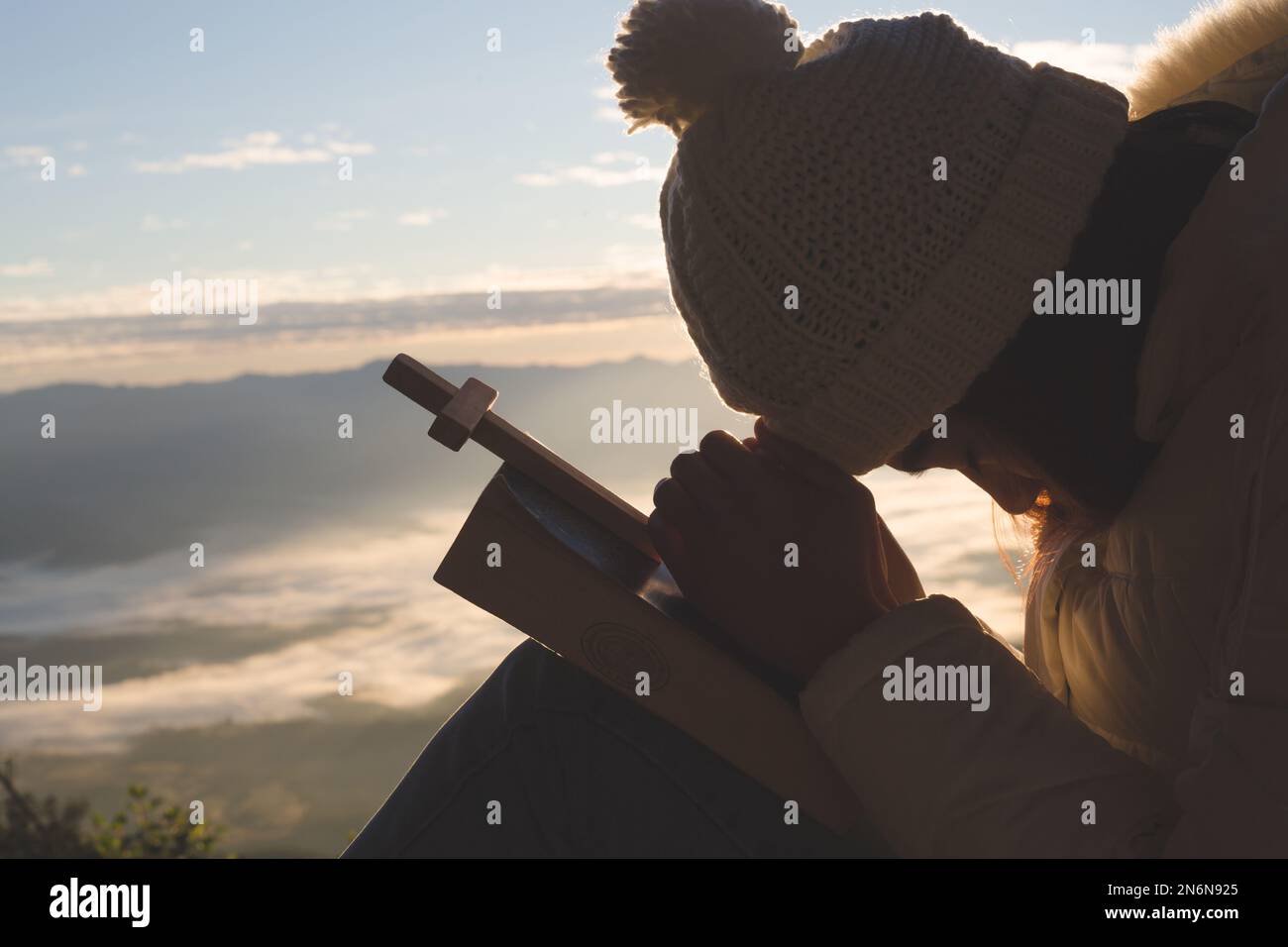Women pray to god with the cross on the mountain background with ...