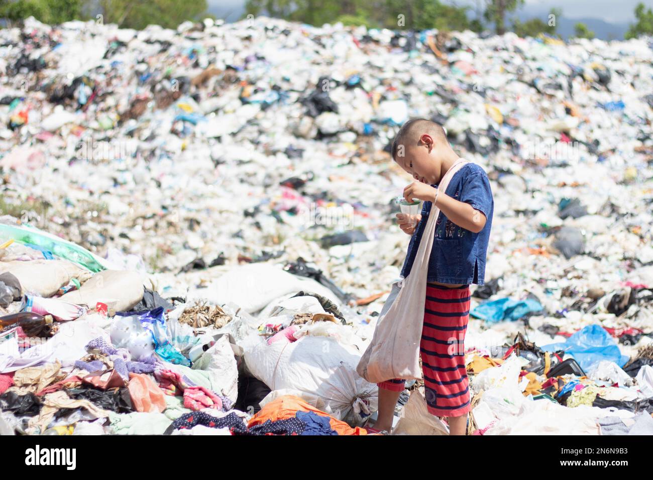 Poor boy collecting garbage in his sack to earn his livelihood, The ...