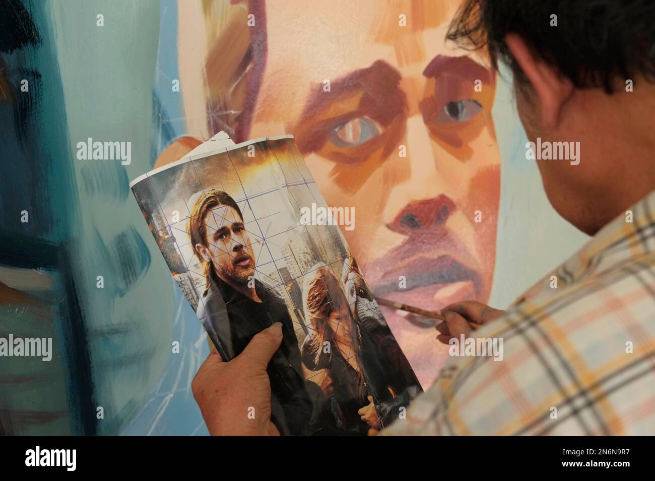 In this Friday, Sept. 6, 2013 photo, local artist Yan Jhen-fa paints a ...