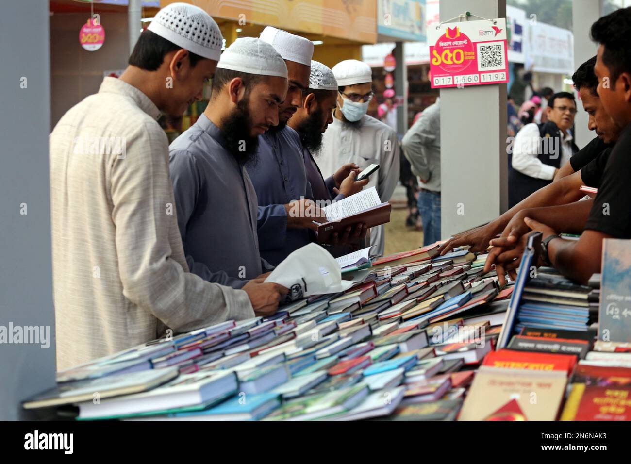 Dhaka, Bangladesh, February 9, 2023. Visitors read books at the ...