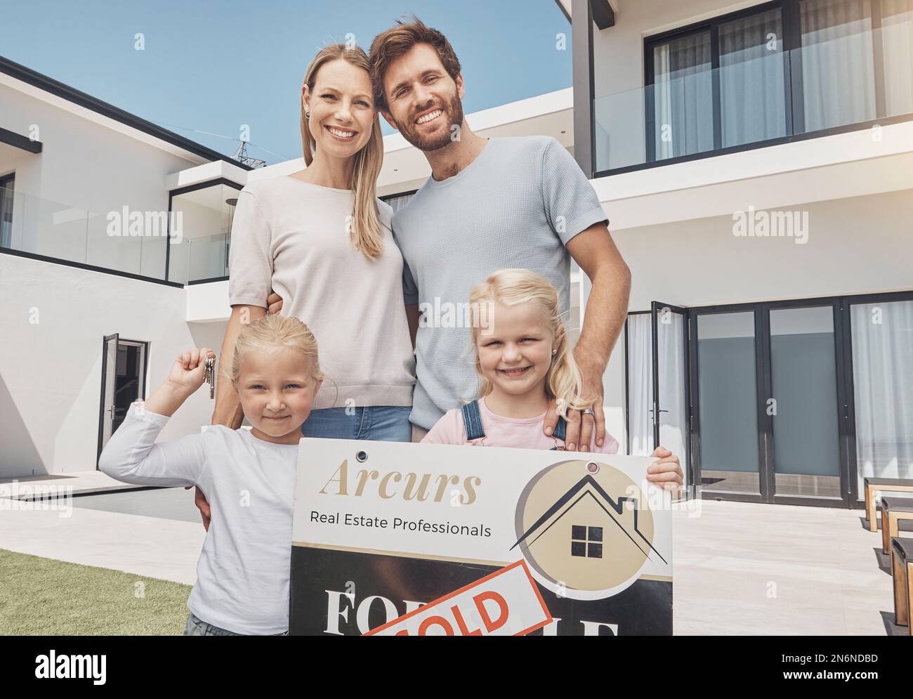 Family smiling outside sold house hi-res stock photography and images ...
